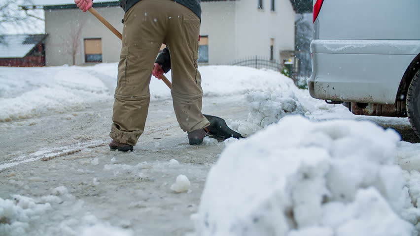 Moving A Big Pile Of Snow. Man With A Shovel In His Hands Moving A Pile ...