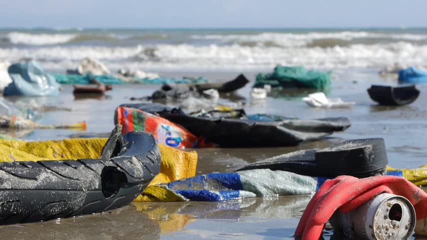 Pan Close Up Shot Of Trash And Rubbish On Sand Of Seashore On Sea ...