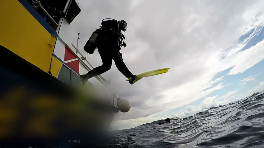 Scuba Diver Jumping Into The Ocean. In Slow Motion A Scuba Diver Jumps ...