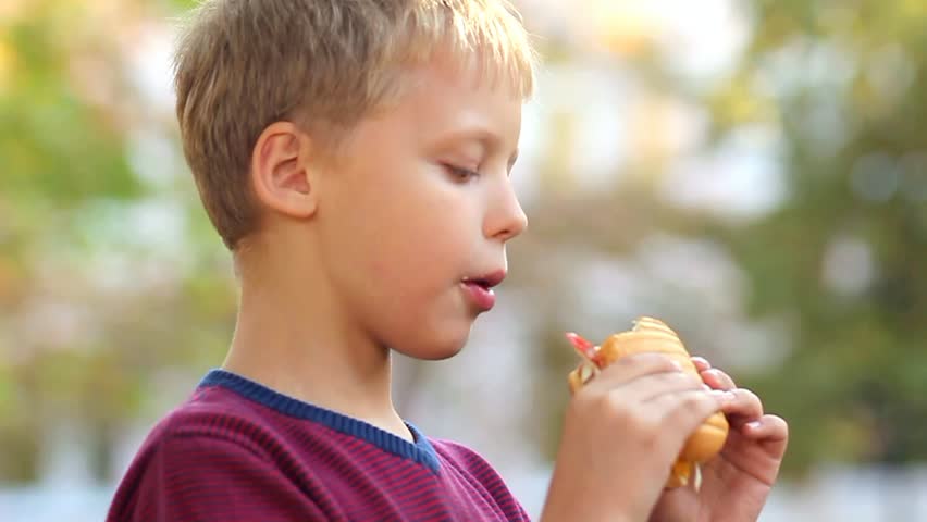 Stock Video Clip of Closeup of child eating hamburger. Slow motion ...