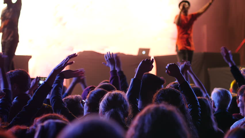 Crowd Partying At A Rock Concert. Silhouetted Hands And Flashing Lights ...