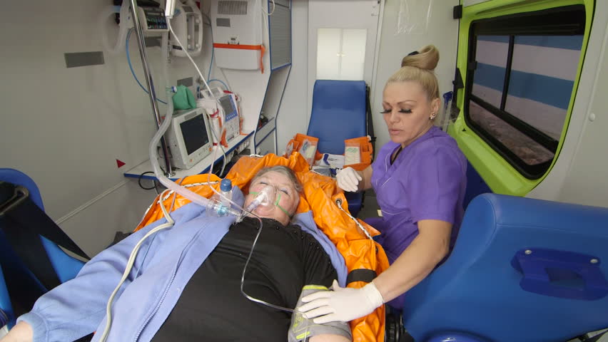 EMT Paramedic Provide Medical Care To Critical Senior Patient Wearing ...