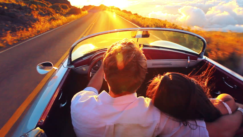 Happy Couple Driving On Country Road Into The Sunset In Classic Vintage ...