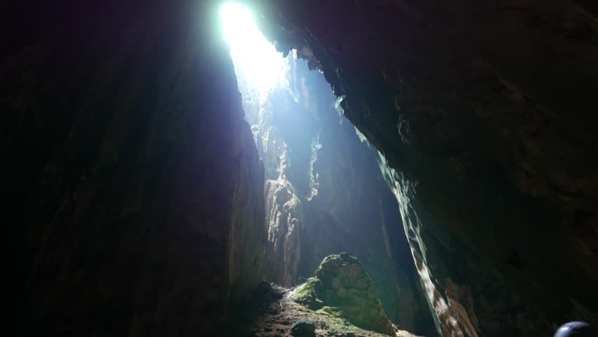 Dim Light In Dark Cave, Rocky Floor And Narrow Gap Showing Lighten Area ...