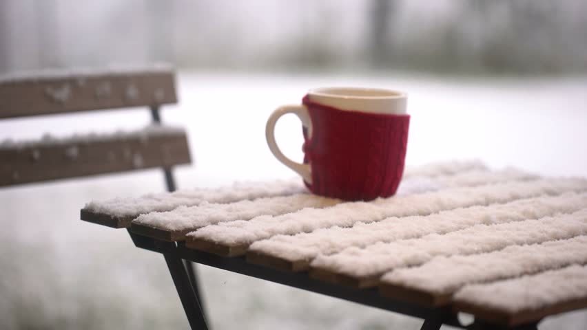 Close Up Of Cup Of Coffee On A Wooden Table Covered In Snow While ...