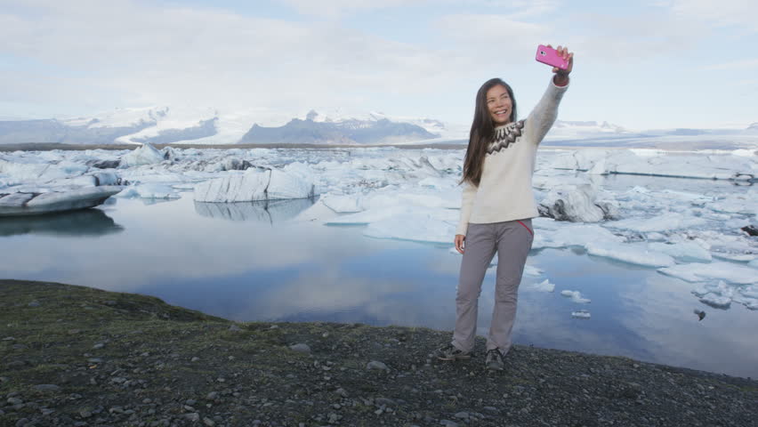 Tourist Taking Selfie Photo With Phone In Iceland. Woman Taking Self ...