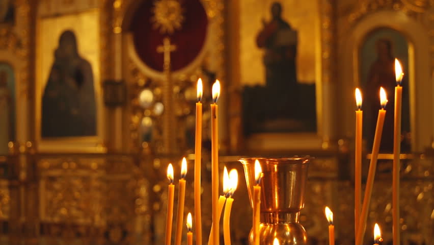 Many Burning Candles In Russian Orthodox Church. Ancient Icons Are Seen ...