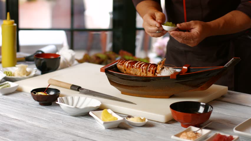 Stock Video Clip of Hands putting spice onto sushi. Guy preparing ...