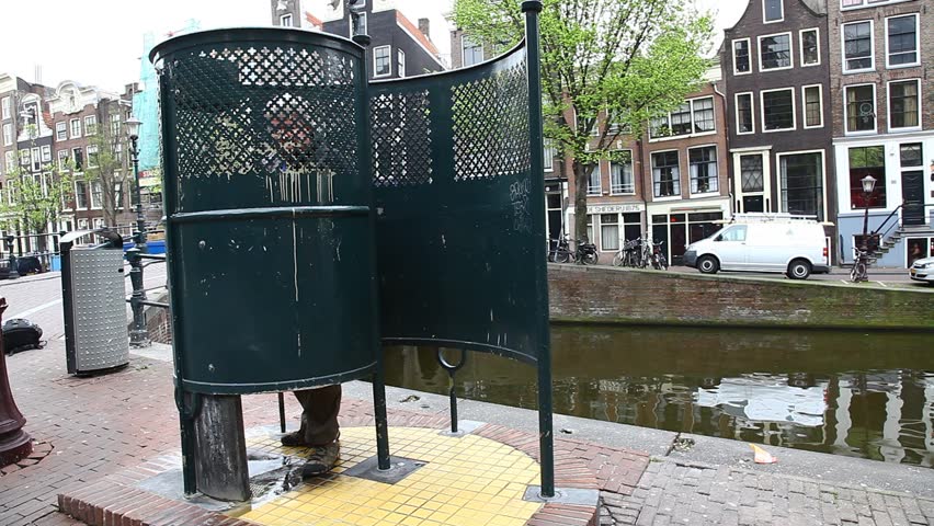 AMSTERDAM - CIRCA APR 2011: A Man Uses An Outdoor Public Urinal During ...