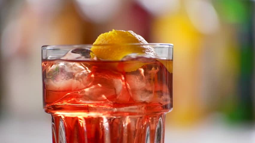 Glass With Red Cocktail Rotates. Lemon Peel Inside A Drink. Try The ...