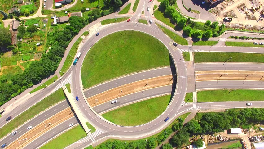Aerial : Traffic Flowing On A Roundabout View From Above Wider View ...
