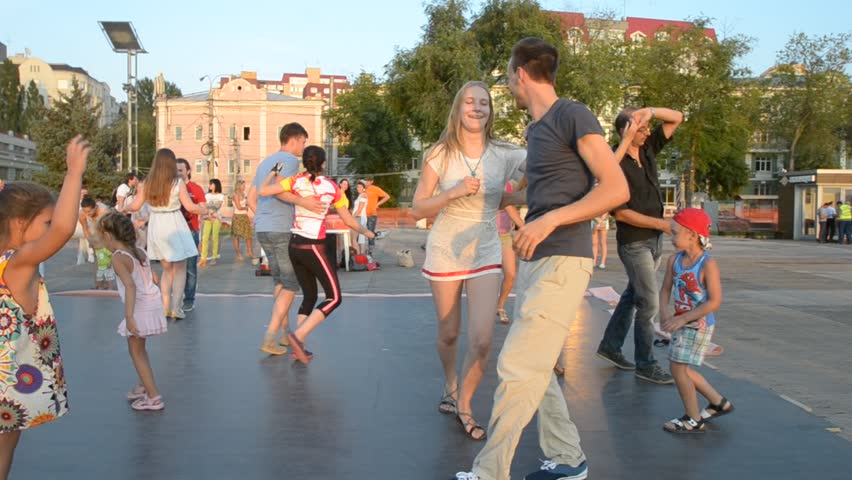 A Happy Group Of Neighborhood Residents Dance In The Street. Stock ...