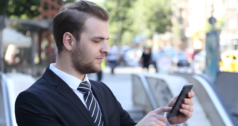 Man Walking Down The Street And Using Cellphone, Steadycam Shot Stock ...