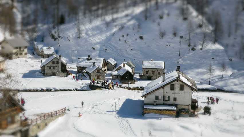 Clouds Above Snow Covered Village Near Forest During Snowfall At Winter ...