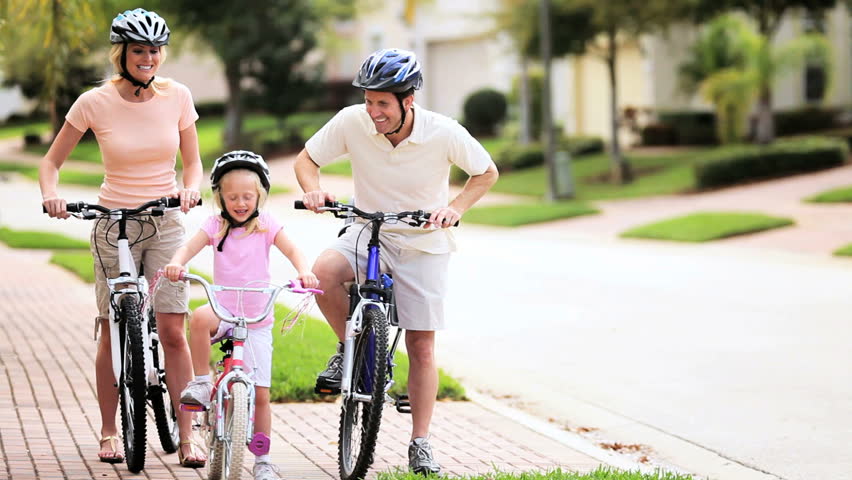 Happy Family On A Bike Ride In The Park Together On A Sunny Day Stock ...