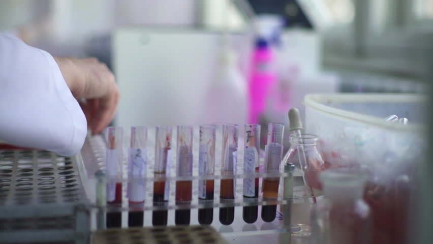 Stock video of laboratory technicians arranging test tubes with ...