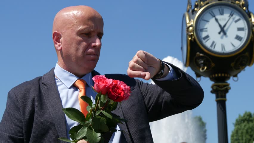 Stock Video Clip of Disillusioned Man with Bunch of Flowers Waiting ...