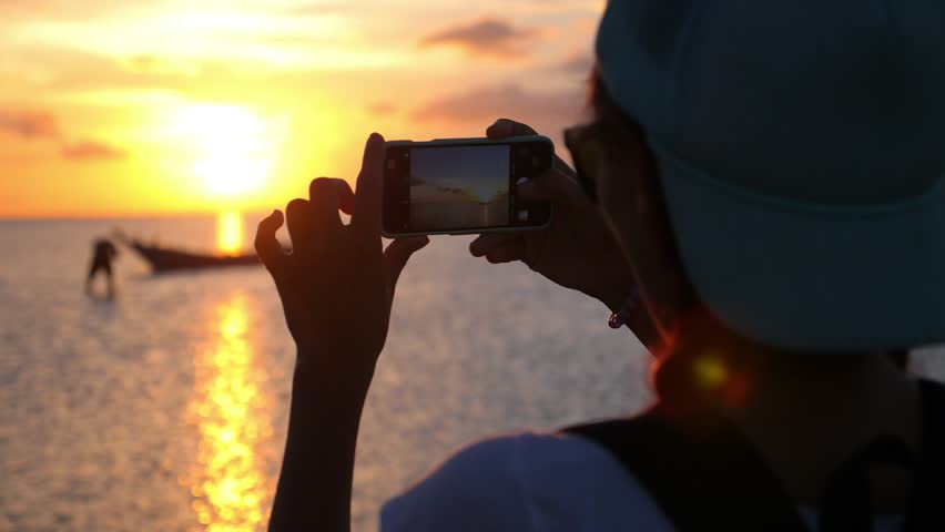 woman-looking-back-at-camera-holding-a-smartphone image - Free stock ...