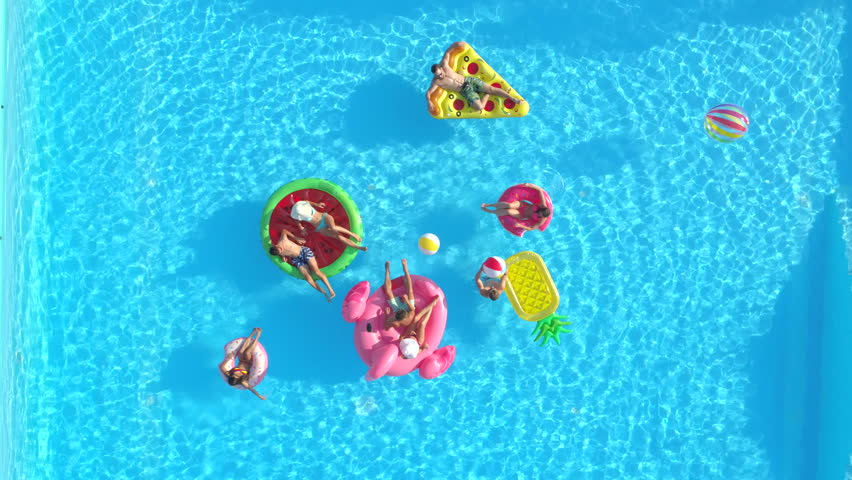 AERIAL: Cheerful Friends Having Water Gun Fight On Colorful Floaties At ...