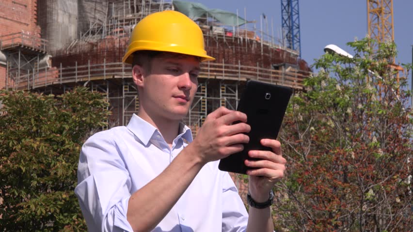 Stock Video Clip of Handsome young builder constructor smiling cheerful ...