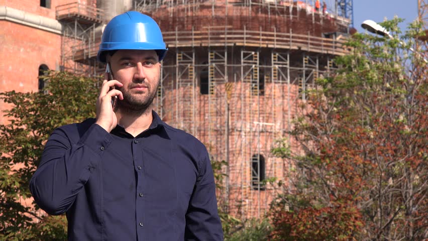 construction builder engineer with helmet talking stok videosu ...