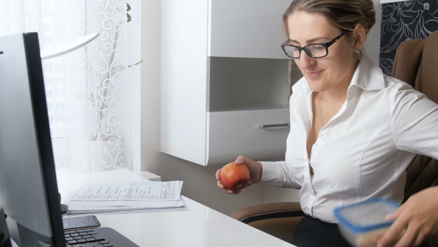 Businesswoman Eating Lunch At Her Desk In Her Office Stock Footage ...