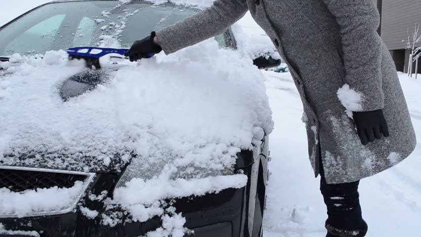 Stock video of woman clean remove snow from car | 3471101 | Shutterstock