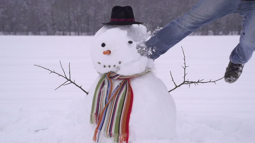 SLOW MOTION CLOSE UP: Young Man In Winter Wear Jumping Into A Snowman ...