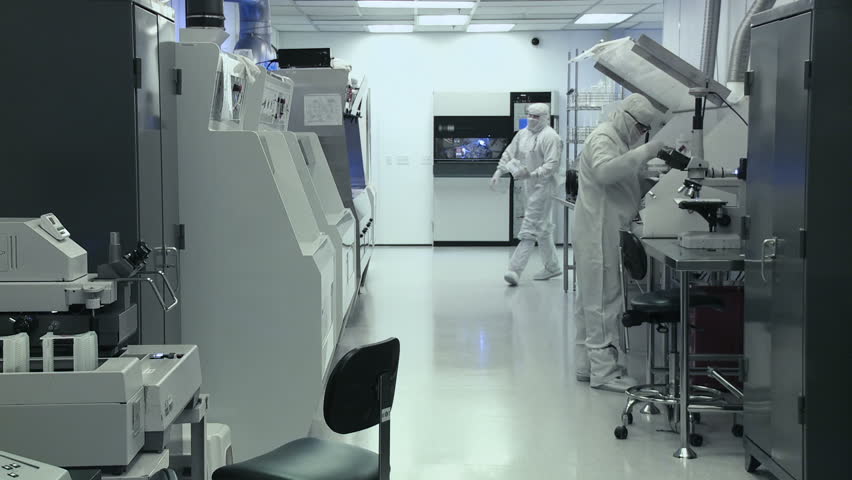 Clean Room Wide. Scientists / Technicians Working On Silicon Chip ...