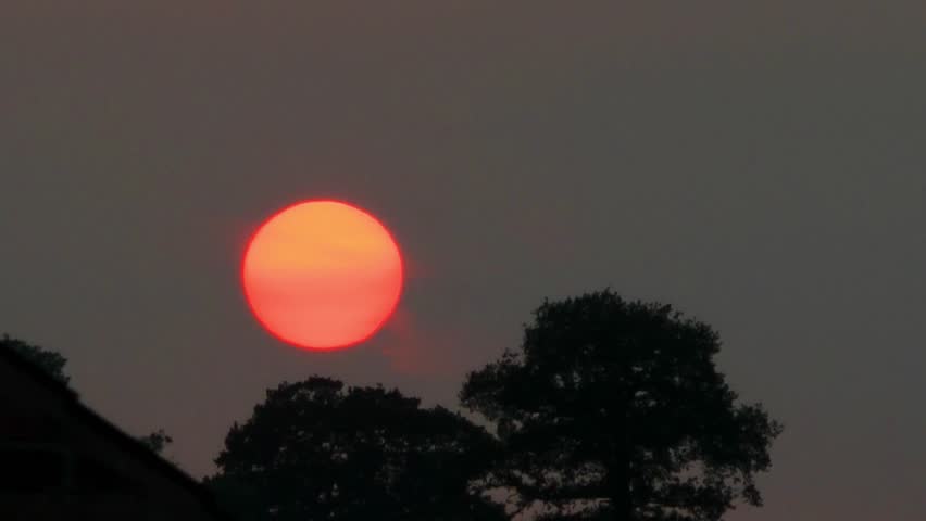 Big, Red Fireball Sun Sinking Into Purple Sky At Sunset At Oyster Bay ...