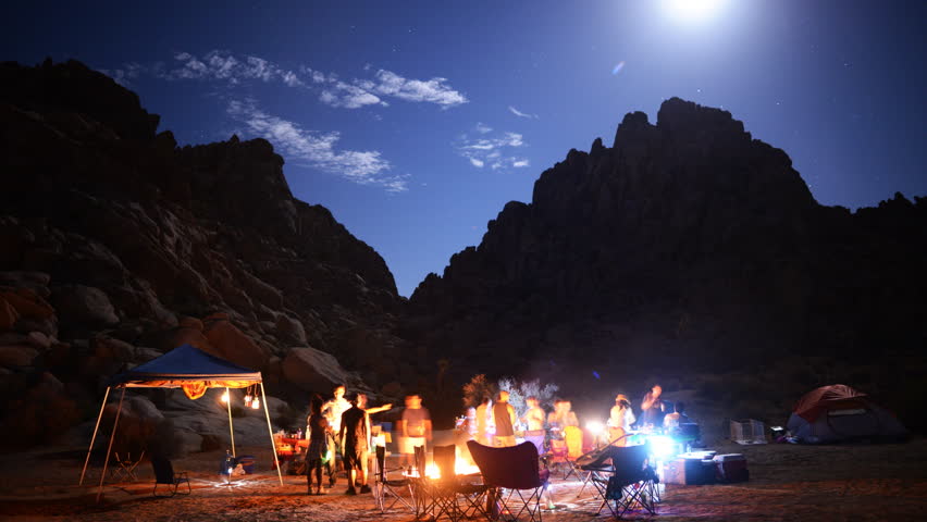 4K Time Lapse Of People Enjoying Camping Around Bonfire In Desert At ...
