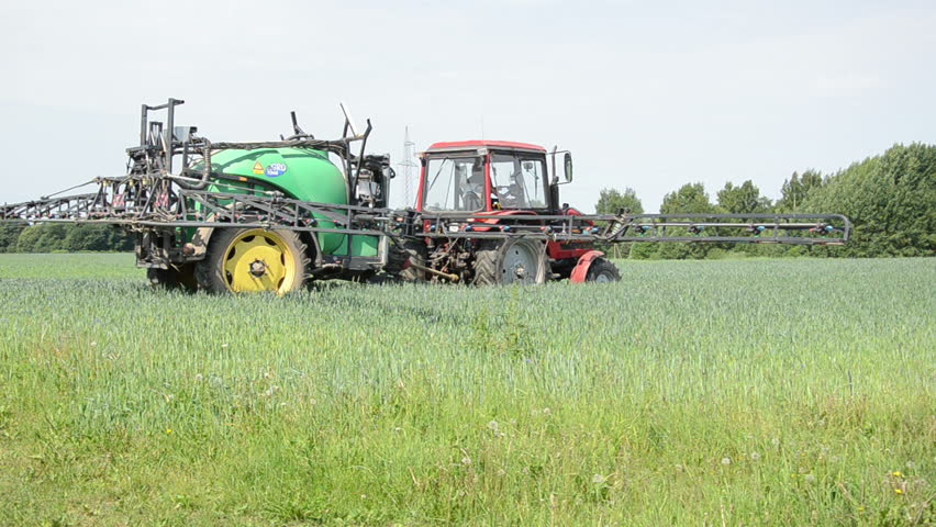 Tractor Pulls Tank With Fertilizer From The Sprinkler Spray On A Small ...