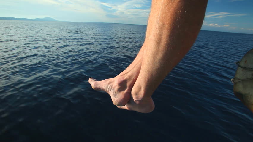 Man Sitting At The Bow Of The Boat With Feet And Legs Overboard Stock ...