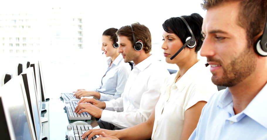 Smiling Business People With Headsets Working In A Call Centre Stock ...