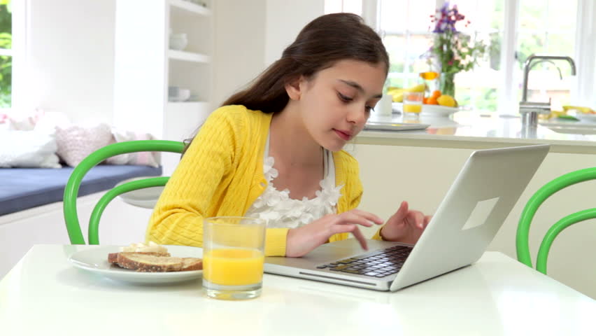 Stock video of girl sitting at kitchen counter eating | 5886431 ...