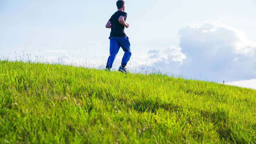 Wide Shot Man Running On Hill In Slow Motion. Beautiful Nature ...