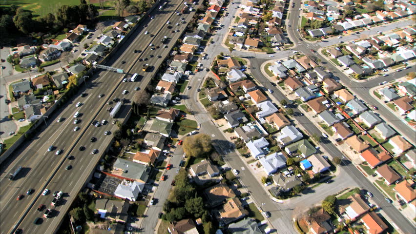 Aerial View Of Traffic On A Freeway With Suburban Housing Either Side ...