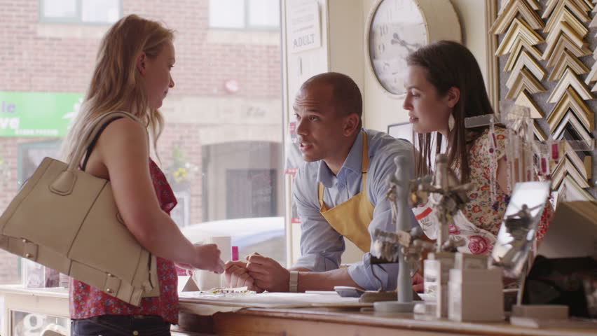 Customers Browsing And Shopping In Local Gift Store. Purchasing ...