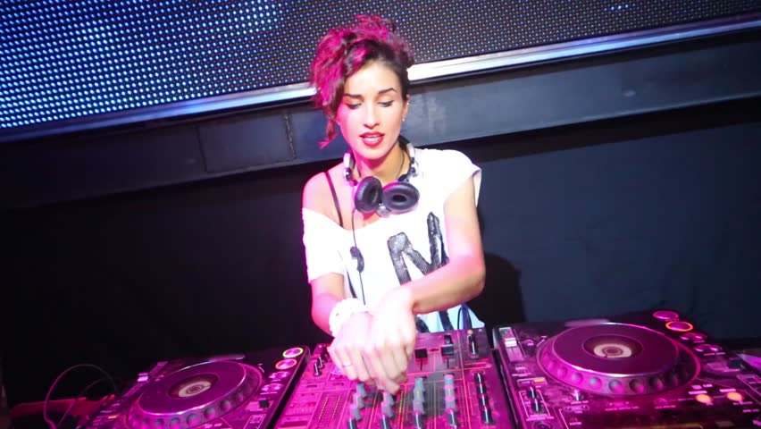 DJ Girl With Headphones Dances Behind Machine In Nightclub Stockvideos ...