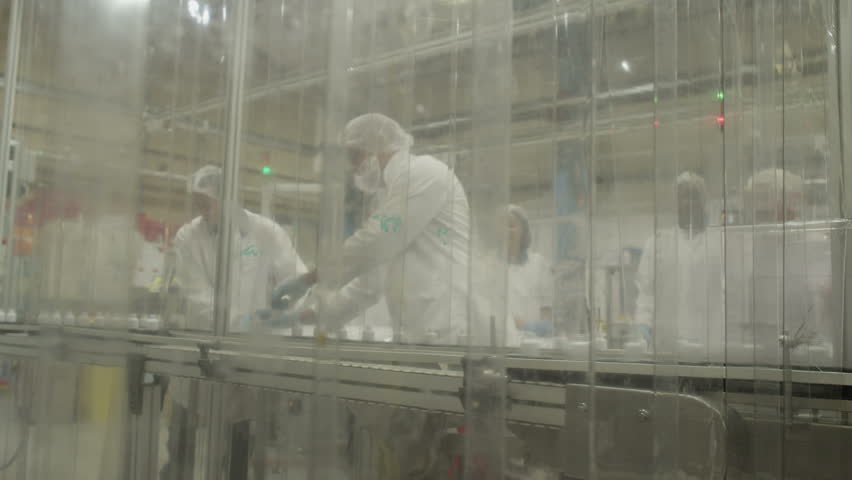 4K Production Facility Team Staff Together On Factory Floor. Smiling ...