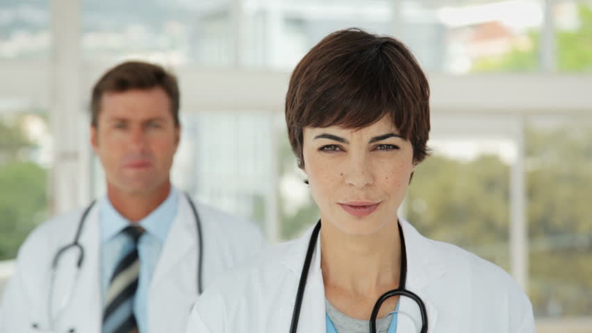 Female Pharmaceutical Company Representative And Young Male Doctor ...