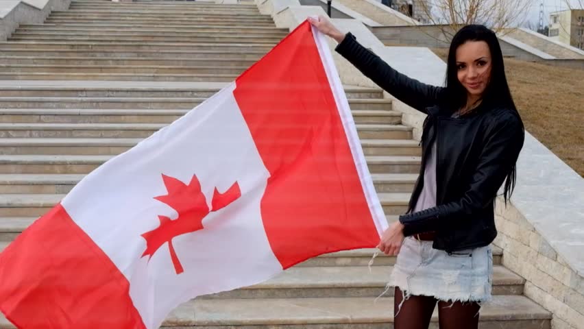 Beautiful Girl Dancing With A Canada Flag Outdoors On Green Grass Stock ...